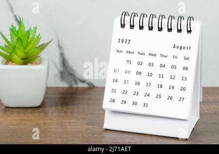 The August 2022 desk calendar with plant on wooden table Stock Photo ...