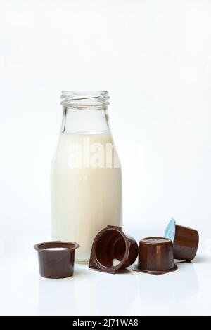 A bottle of milk and milk in portion pack, white background Stock Photo ...