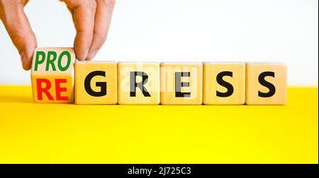 Regress or progress symbol. Businessman turns wooden cubes and changes ...