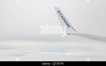 A picture of a Ryanair wing flying between the clouds Stock Photo - Alamy