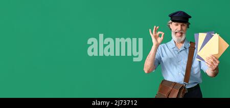 Handsome old postman showing OK on white background with space for text ...