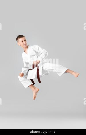 Boy practicing karate on light background Stock Photo - Alamy