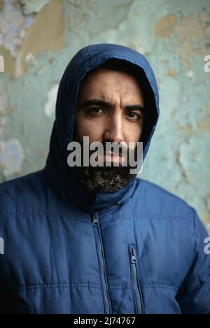 Bearded middle eastern man wearing hooded jacket Stock Photo - Alamy