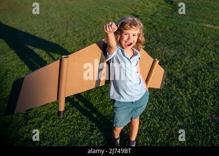 Kid superhero with jetpack. Child pilot play on summer day. Success ...