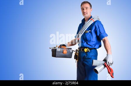Portrait of uniformed plumber with work tools in hands and white ...