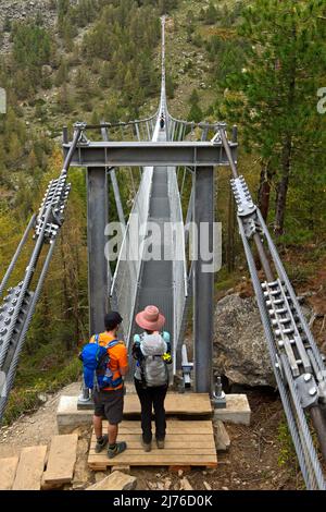 Uphill, hiker climbing on Charles Kuonen suspension bridge, Randa ...