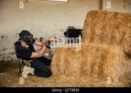 Soldiers aiming airsoft gun during tactical game Stock Photo - Alamy