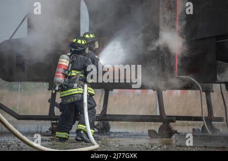 Firefighters assigned to the U.S. Army Garrison Italy, use rope work ...