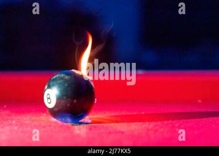 Billiard balls are photographed on fire while sitting outdoors in an ...