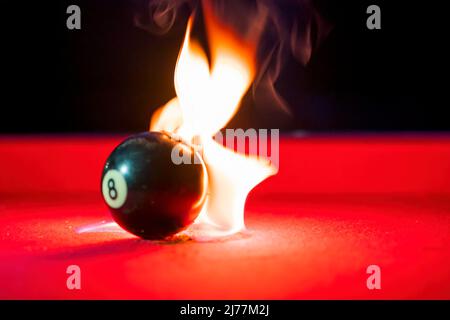 Billiard balls are photographed on fire while sitting outdoors in an ...