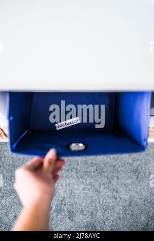 hand grabbing storage cube with Minimalism label inside of it with ...