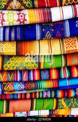 Colorful Andean fabric textiles on the local souvenir market in Otavalo ...