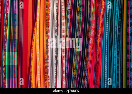 Colorful Andean fabric textiles on the local souvenir market in Otavalo ...