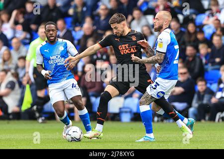 Owen Dale #7 of Blackpool is fouled by Joe Ward #23 of Peterborough ...