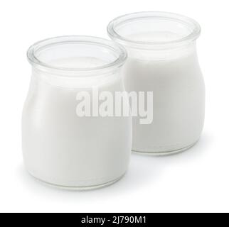 Two glass containers with plain yoghurt and berries on the table. Light ...