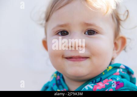 Baby plays snot in the street with a cold nose. Selective focus Stock ...