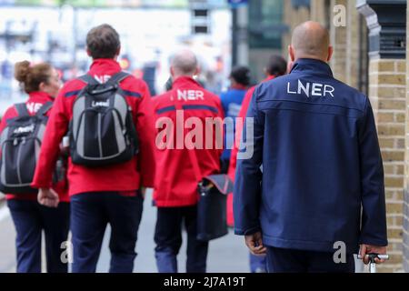 LNER staff making their way to the train at London Kings Cross station ...