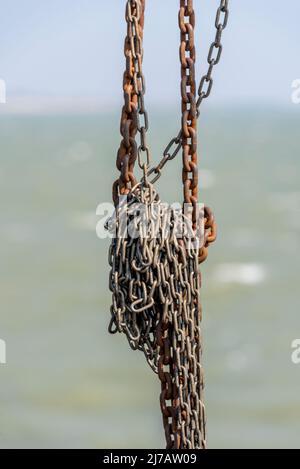 Chain. Bunched chains. Knotted mix of old rusty, and new clean chains ...