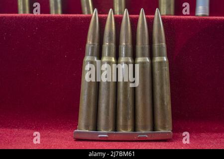many war gun bullets close up detail on red background Stock Photo - Alamy