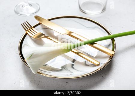 Beautiful table setting with calla lily on light background, closeup ...