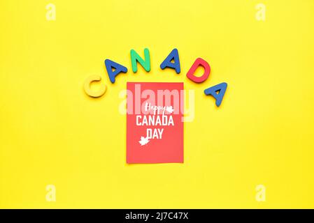 Canada word on a paper card, isolated word with blurred background ...