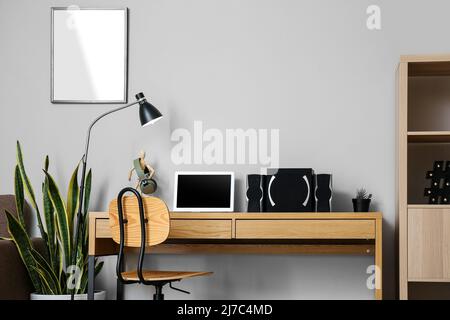 Speakers and modern laptop on table near white brick wall Stock Photo ...