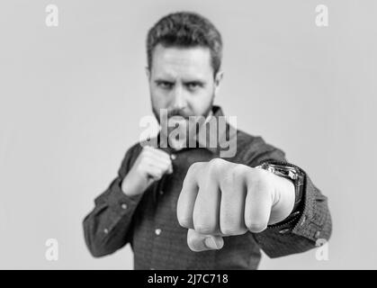 Mature man stand in offensive fighting position with clenched fist ...
