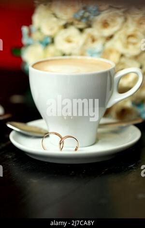 wedding bouquet and coffee with the wedding rings Stock Photo - Alamy