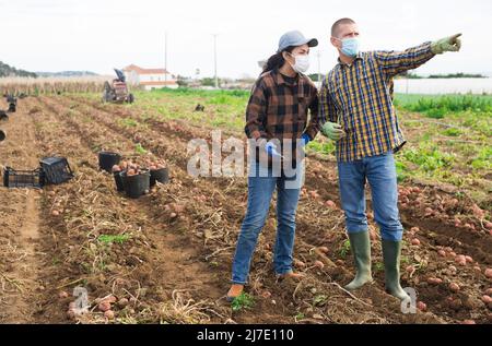 Owner of the farm field tells hired worker where to work Stock Photo ...
