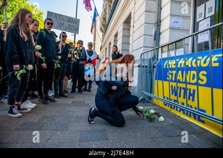 A protester is seen holding a white rose flower during a protest march ...