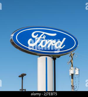 Isolated oval shaped Ford logo, the automobile, with a blue sky ...