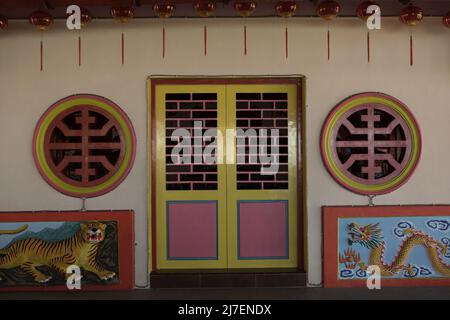 A door decorated with animal figures at Pulo Kemaro temple complex—a ...