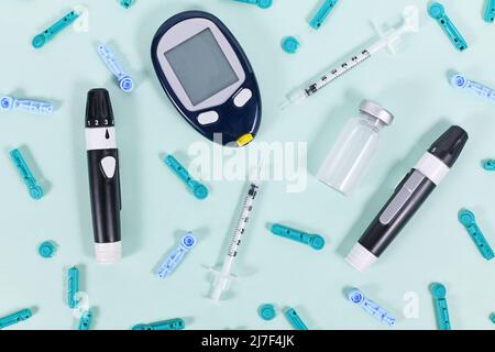Glaucometer and insulin syringe, lancing device tester strip. On white ...