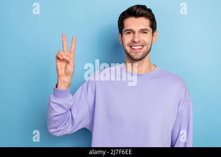 Photo of cool millennial brunet guy show thumb up wear yellow shirt ...