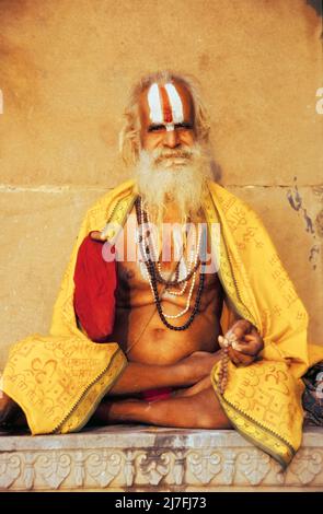 Indian Hindu spiritual guru sitting on stage during religious ceremony ...