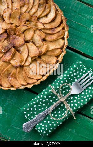 Juicy apple pie with cinnamon and brandy on a green background Stock ...