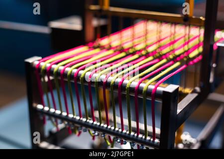 Looms, accessories, woven scarves, colored threads Stock Photo - Alamy