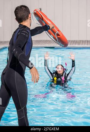 Scuba Diving rescue course surface skills checking for breathing of an ...