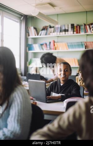 Primary school student sitting at his desk and paying attention during ...
