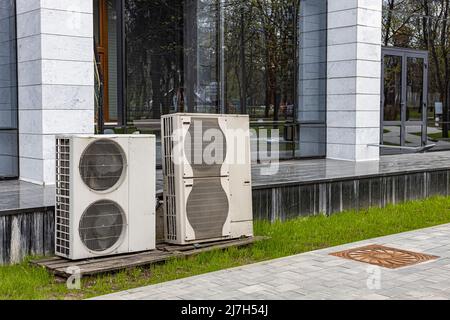 An outdoor air conditioner unit installed on the outer wall of a ...