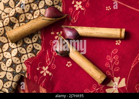 Batik fabrics are made with the use of a canting and hot wax, which is ...