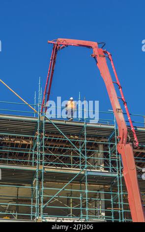 A construction worker in a concrete skeleton of a building on a ...