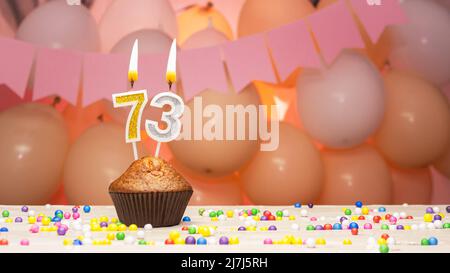 Birthday cake with candle number 73 - Blue background Stock Photo - Alamy