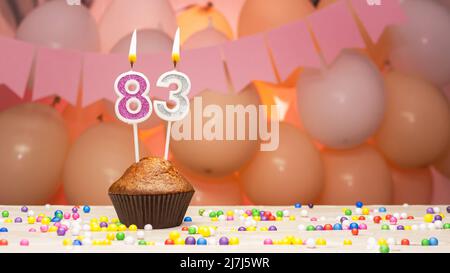 Birthday cake with number 84 candle - Sparkling orange background with ...