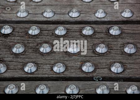 Circular rivets in wood deck Stock Photo - Alamy