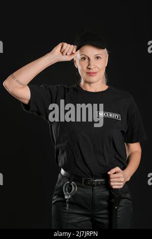 Female security guard on dark background Stock Photo - Alamy