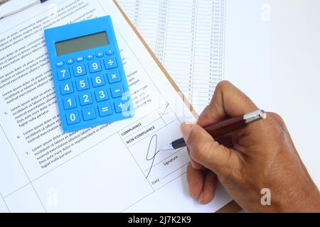 An auditor giving signature at audit report and checked it with the ...