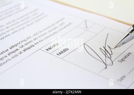 An auditor giving signature at audit report and checked it with the ...