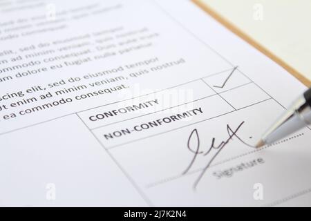 An auditor giving signature at audit report and finalizing the result ...