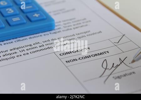 An auditor giving signature at audit report and checked it with the ...